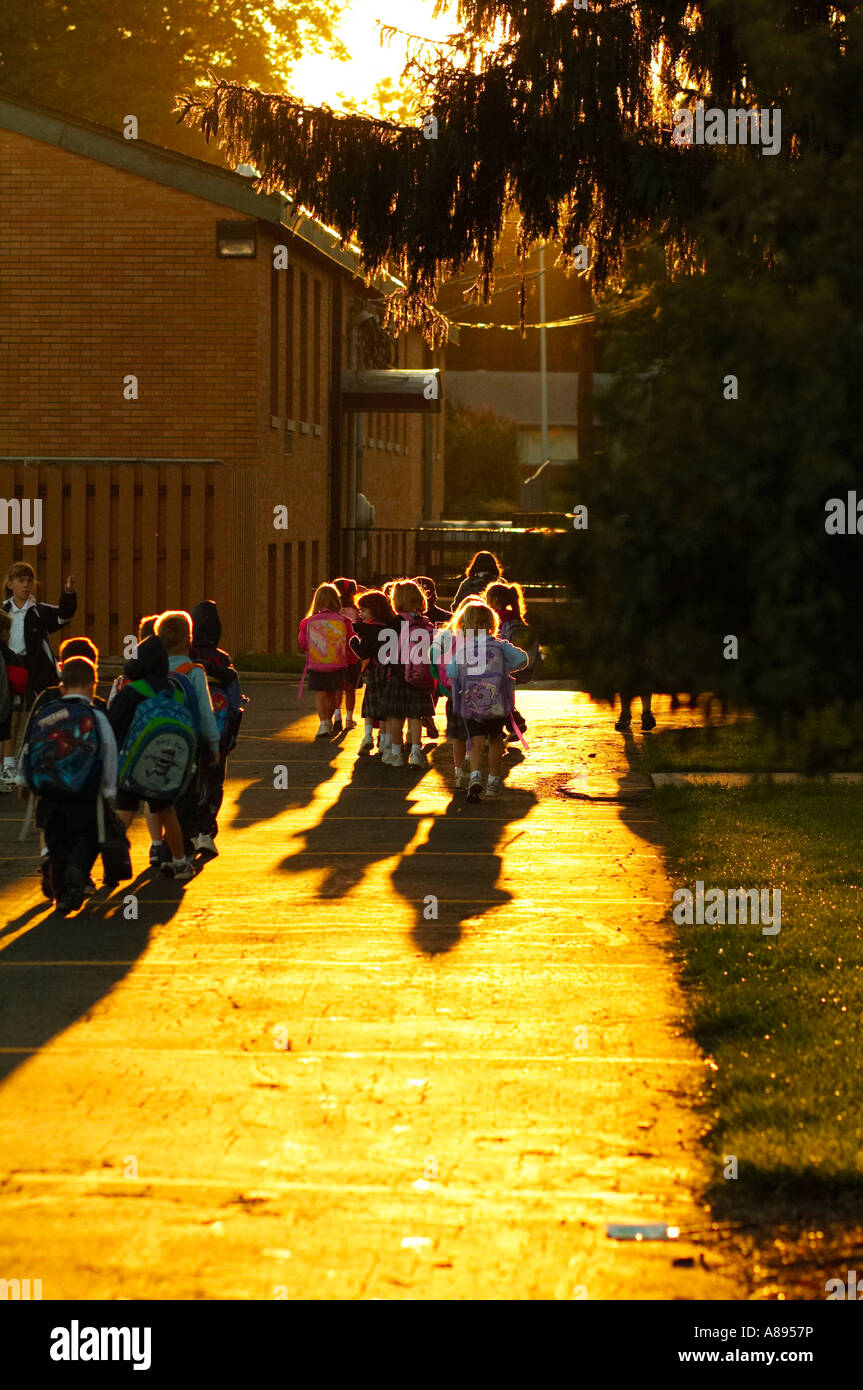 Young school children walking into their school building with dramatic ...