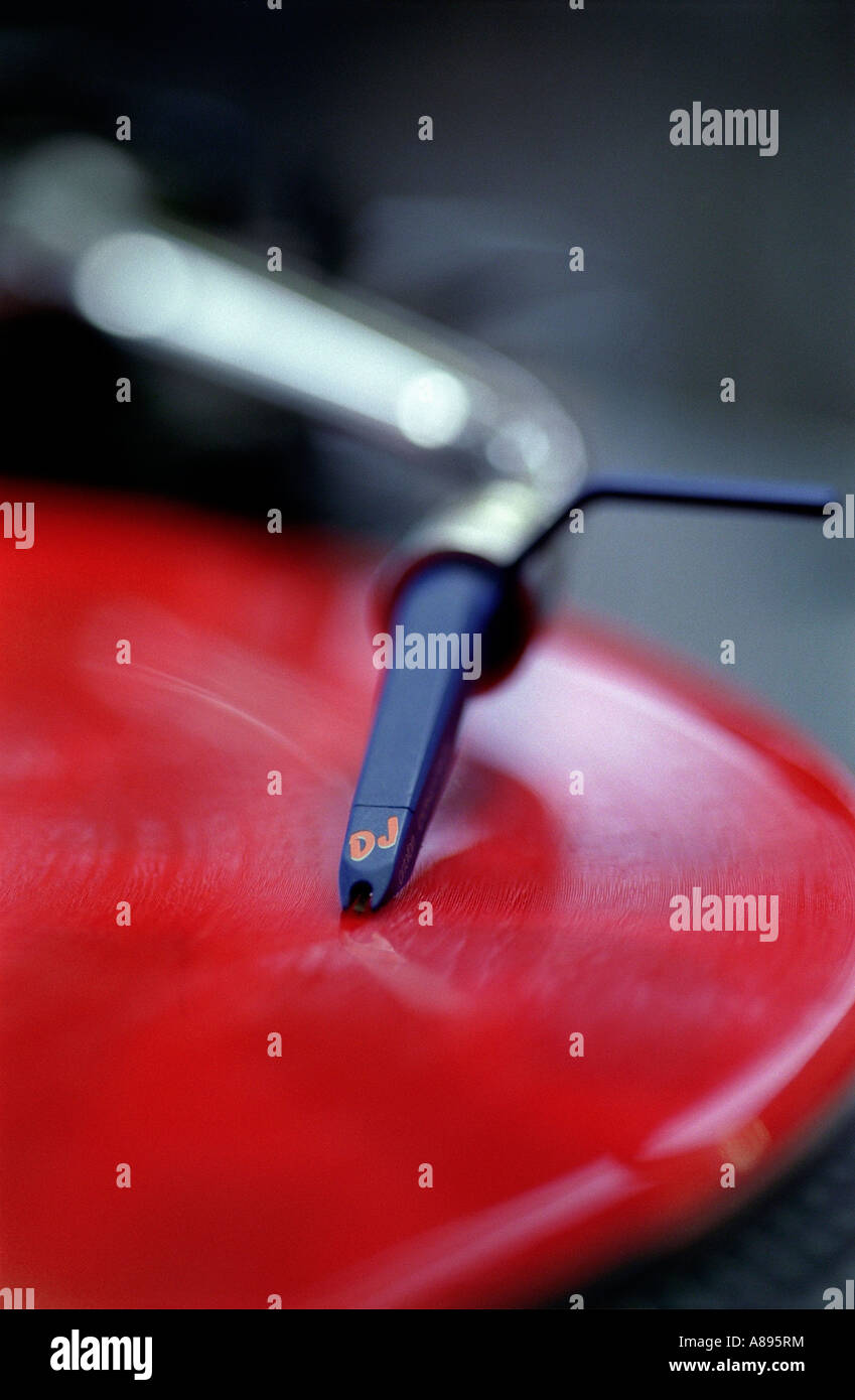 a red record and dj needle on a set of deck Stock Photo - Alamy