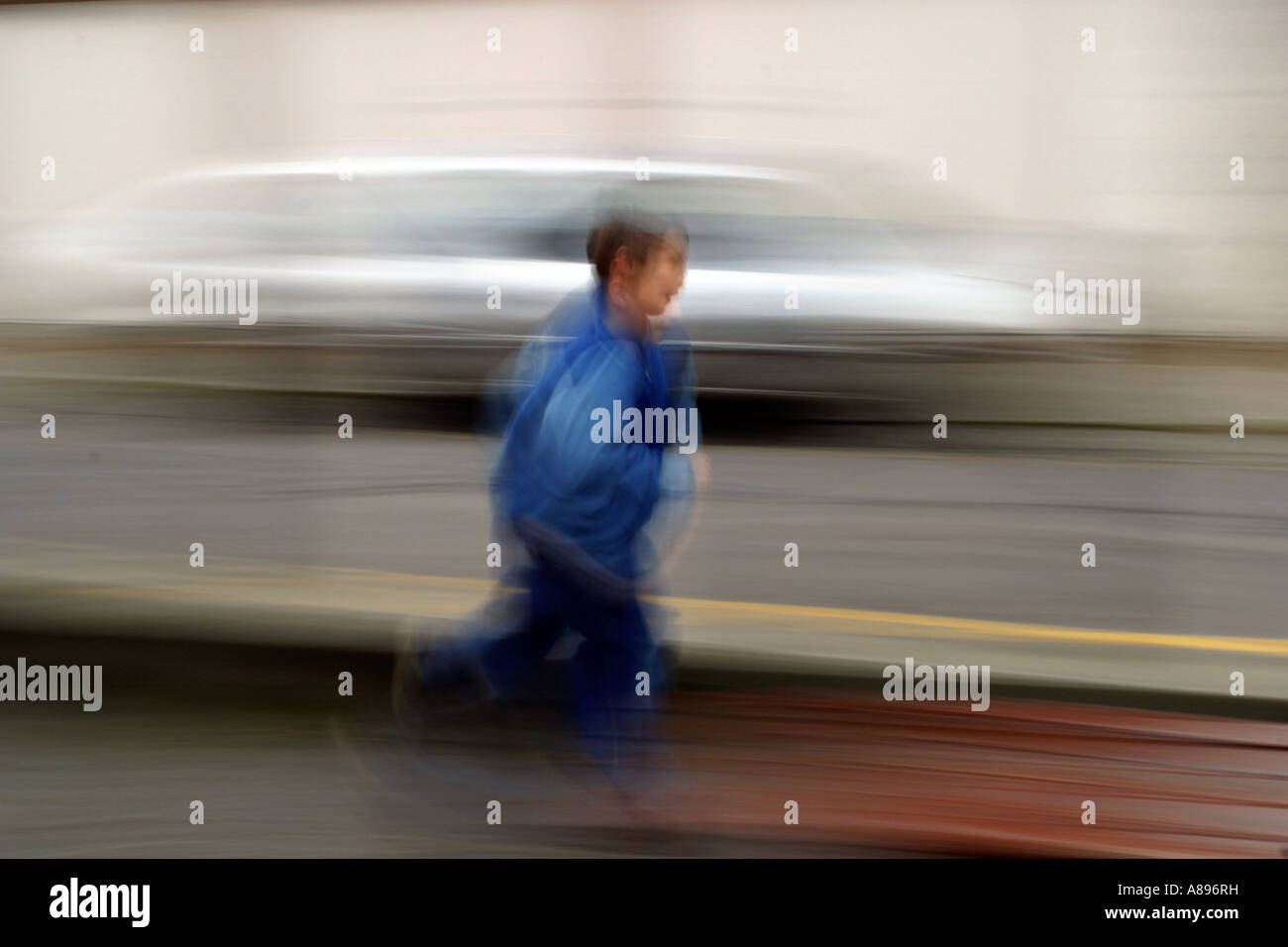 Young boy running in the street Stock Photo - Alamy