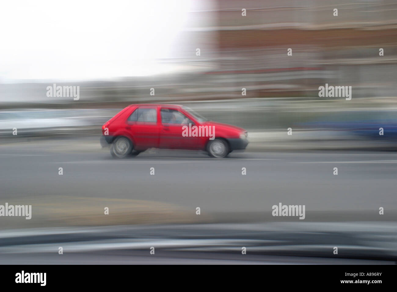 Red Car speeding fast on the road Stock Photo - Alamy