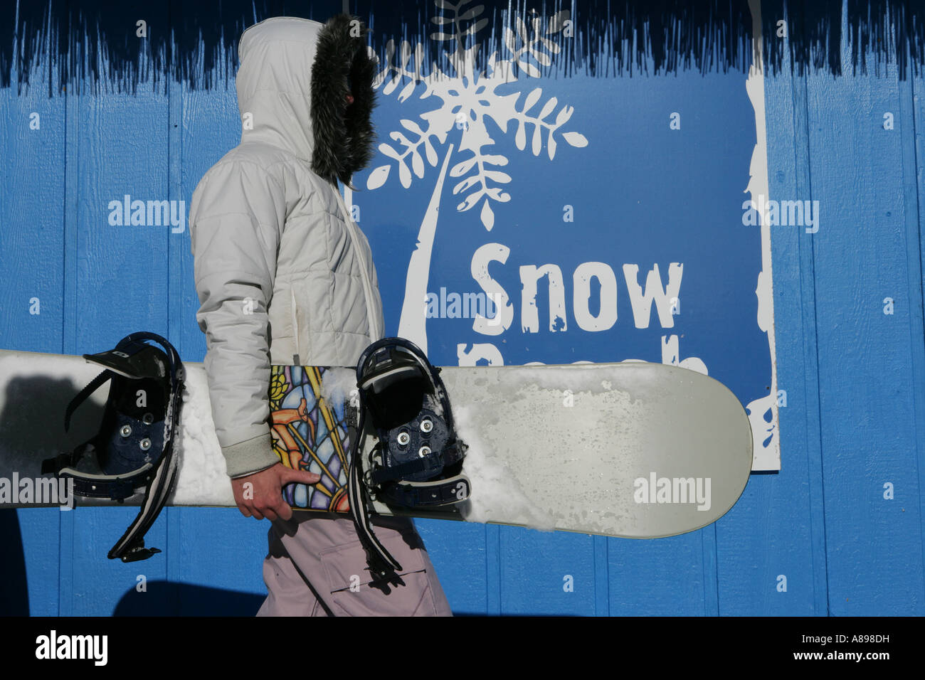 Side view of woman with snowboard Stock Photo - Alamy