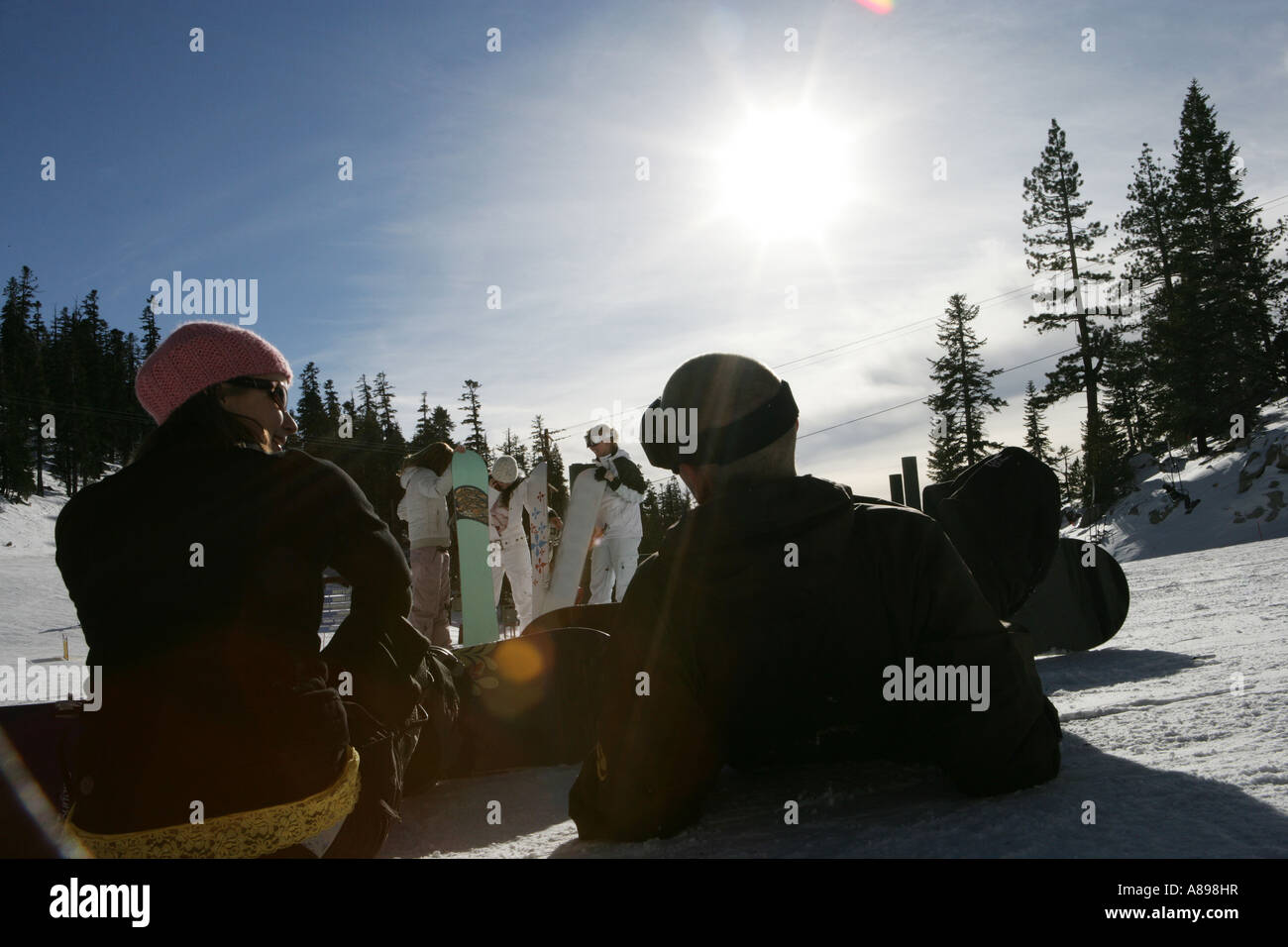 Couple sitting on a ski slope Stock Photo - Alamy
