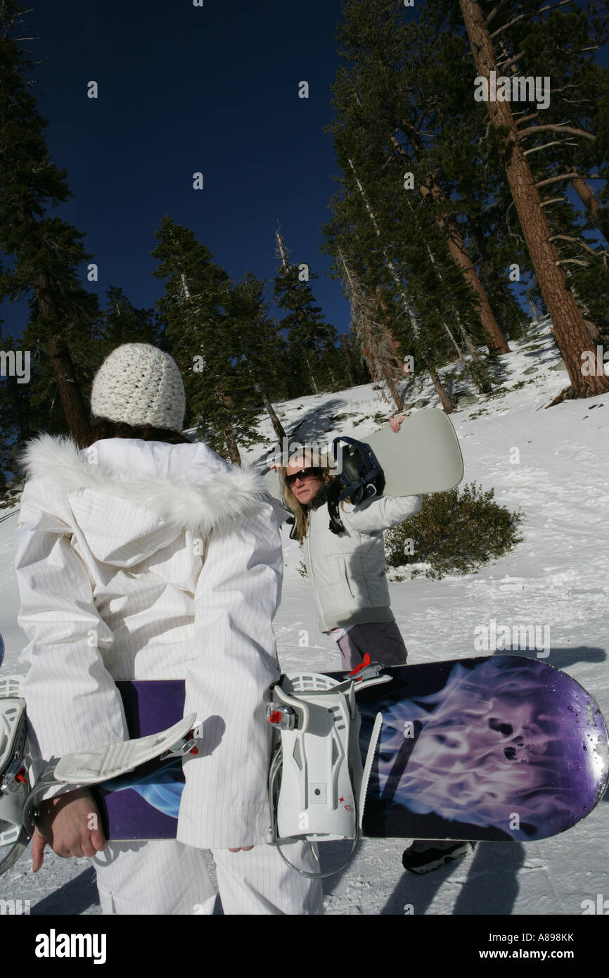 Two women with snowboards on a ski slope Stock Photo - Alamy