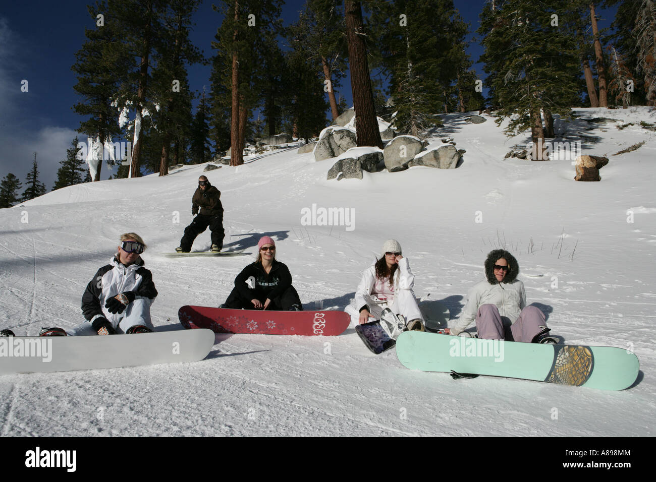 Four women seated on a ski slope Stock Photo - Alamy