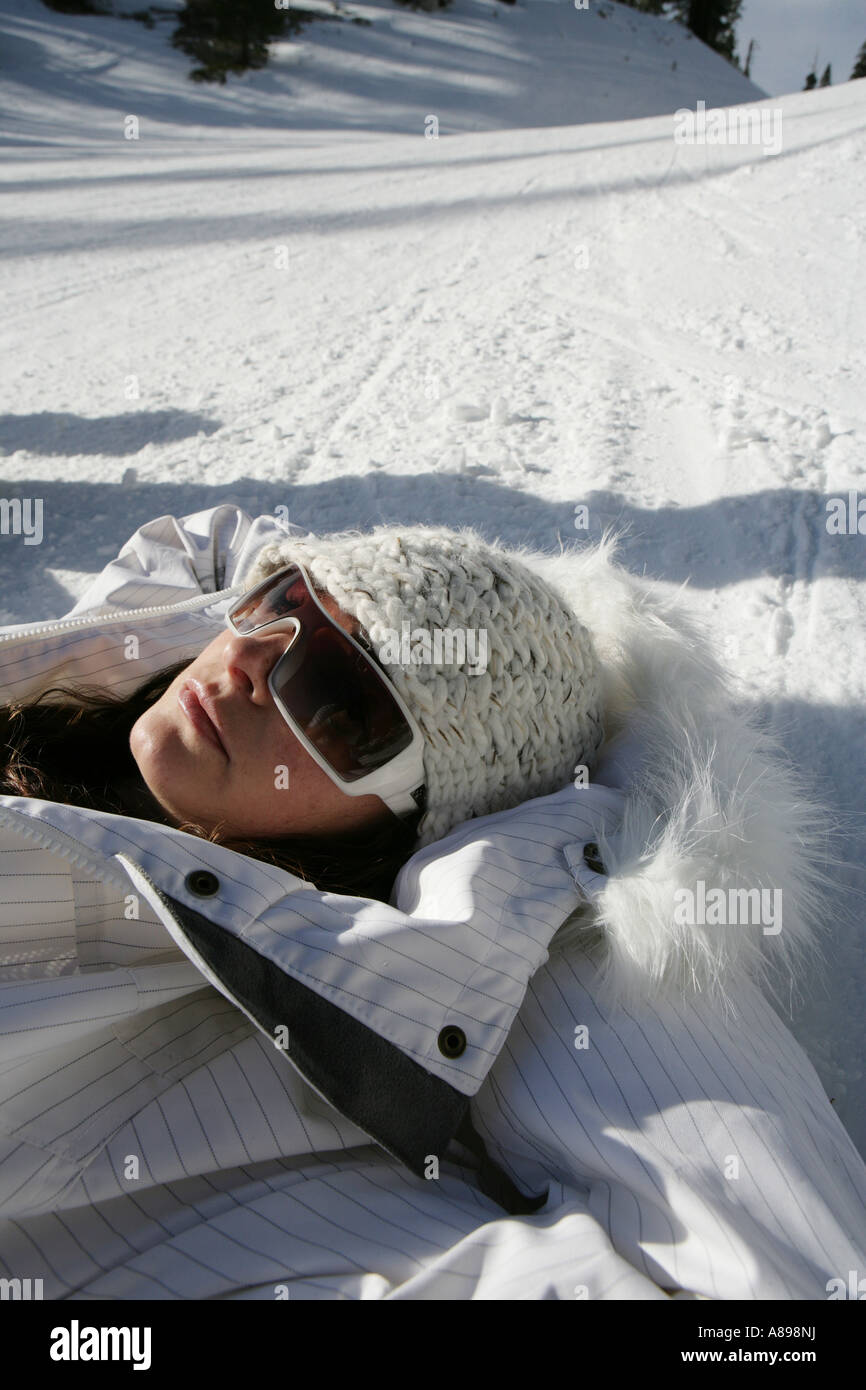 Woman laying down on a ski slope Stock Photo - Alamy