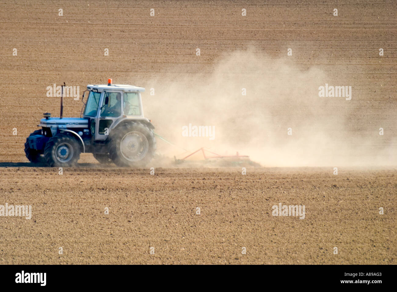 Tractor with harrow Stock Photo - Alamy