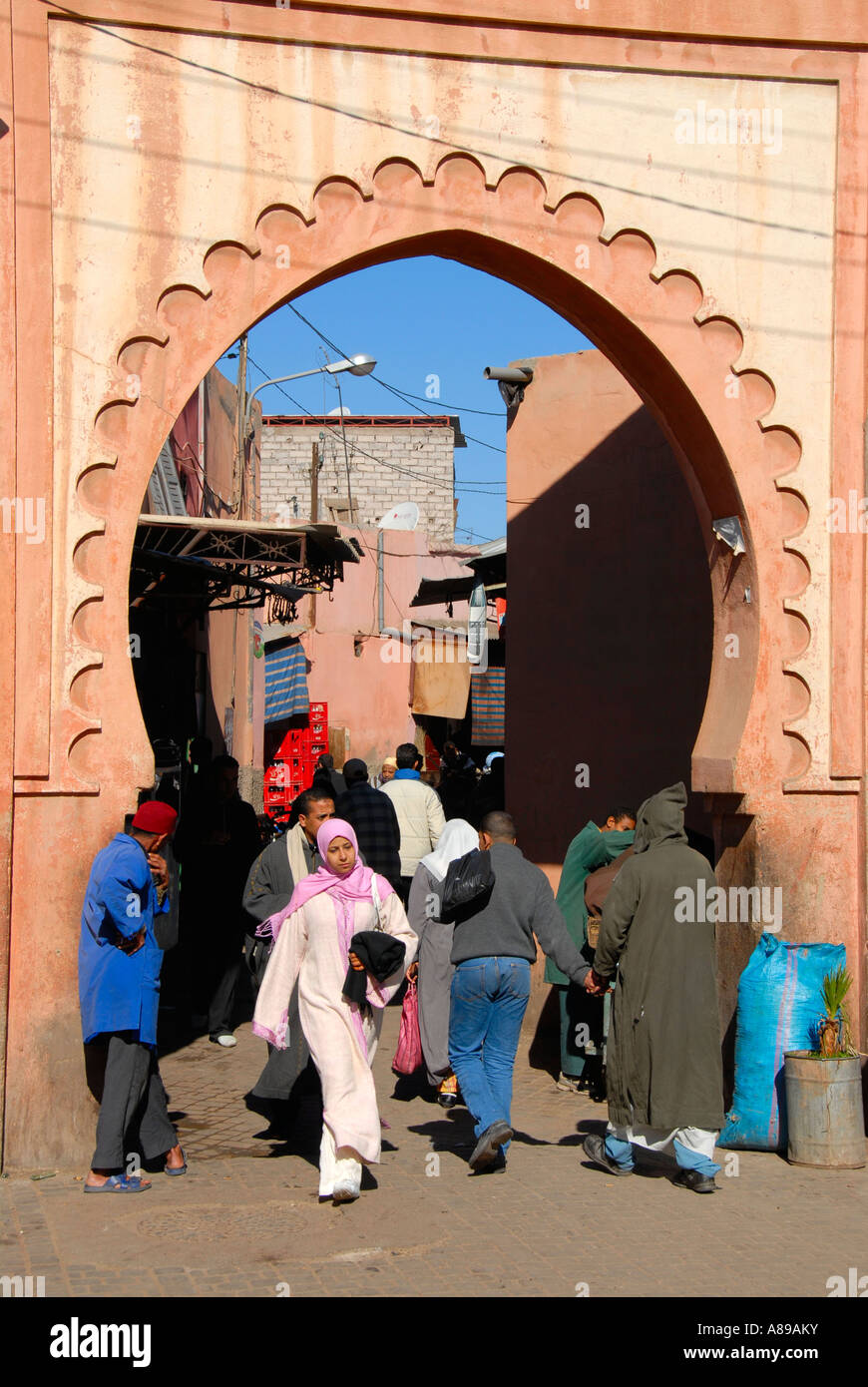 Many people walk through an oriental arch medina Marrakech Morocco ...