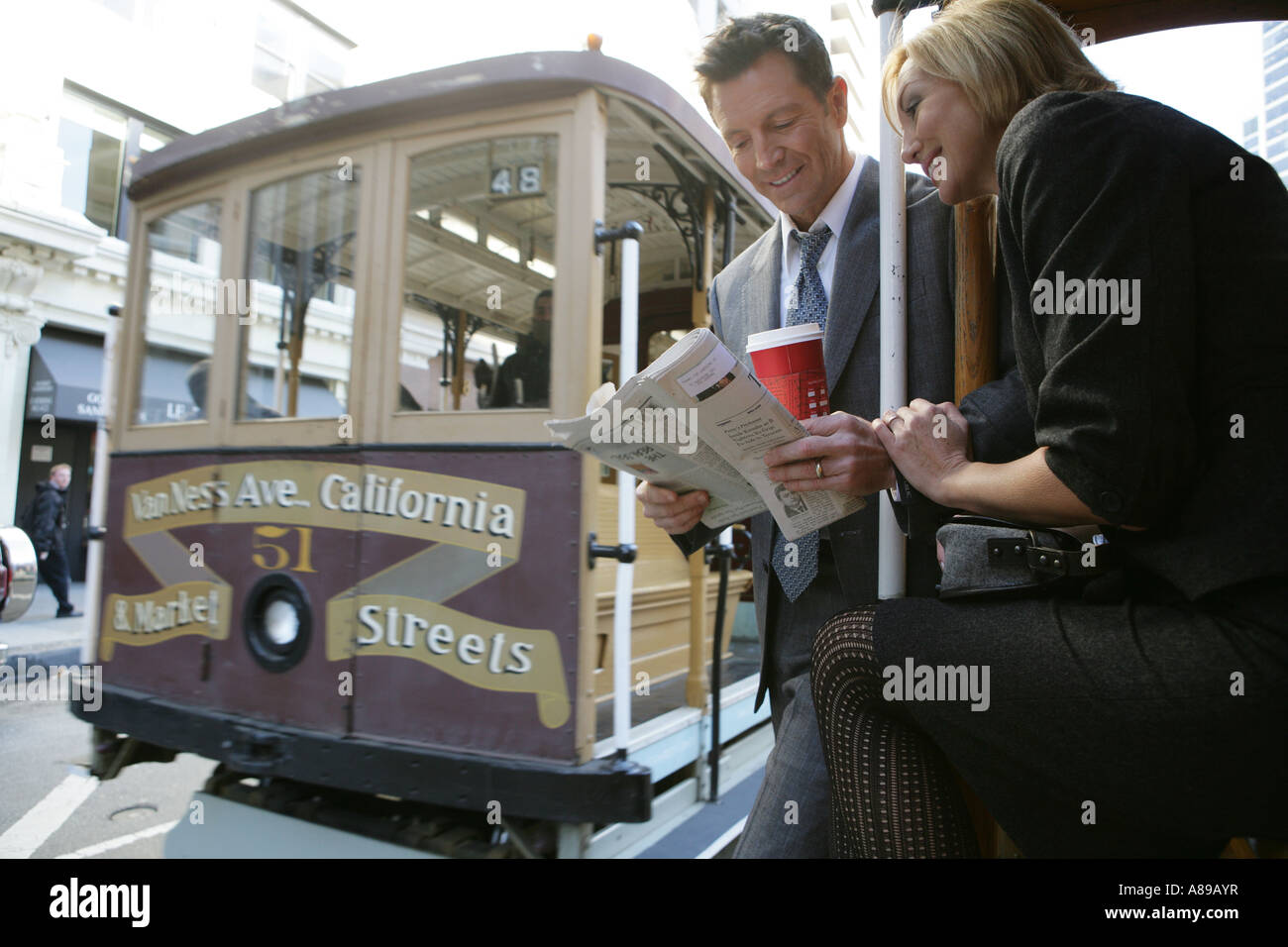 Couple riding a trolley car Stock Photo - Alamy