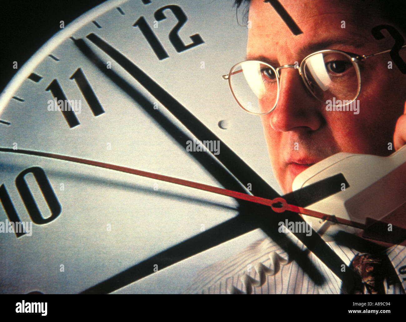 Man on phone with clock Stock Photo - Alamy