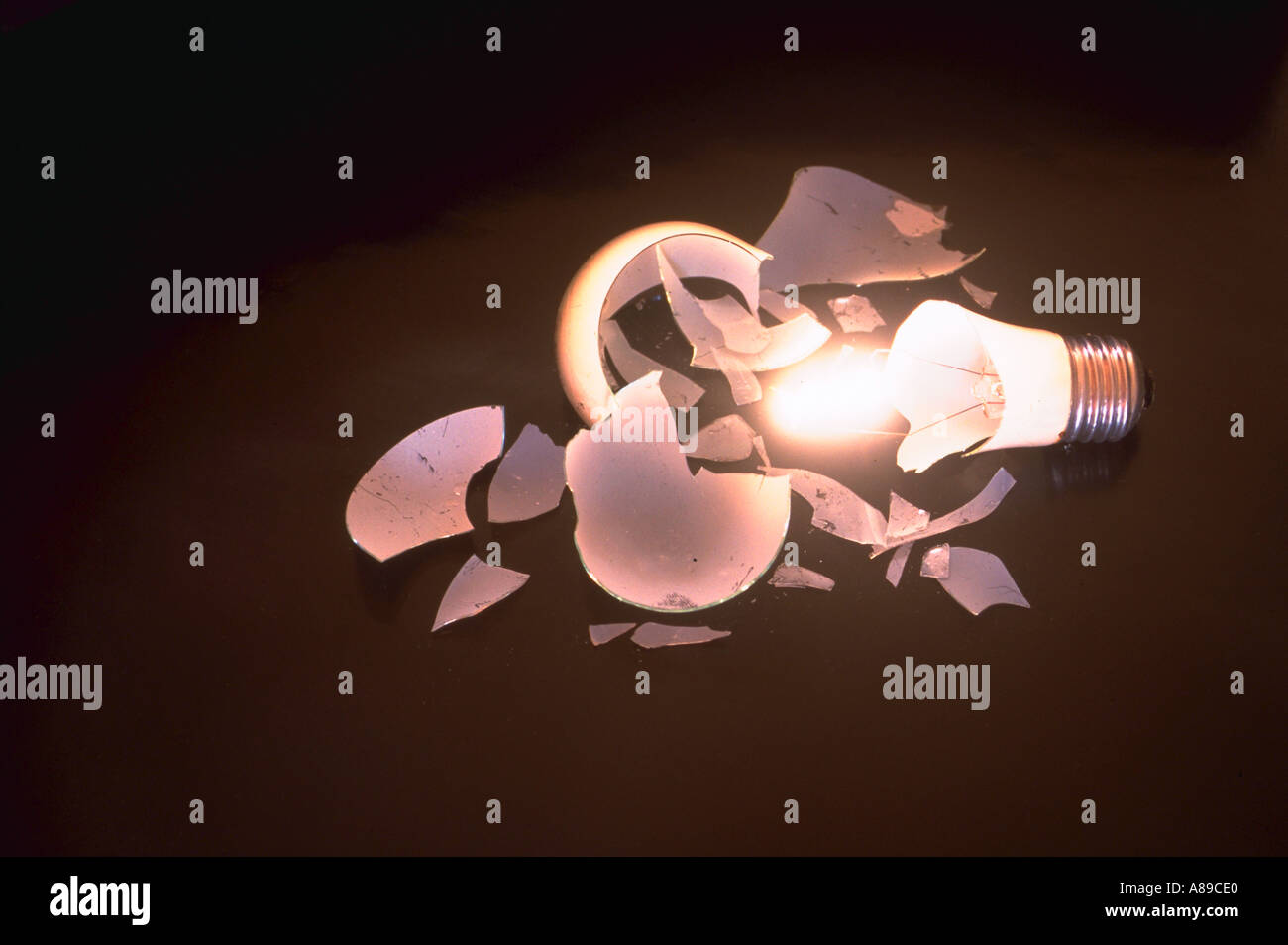 Still life of a shattered light bulb that is still illuminated Stock ...