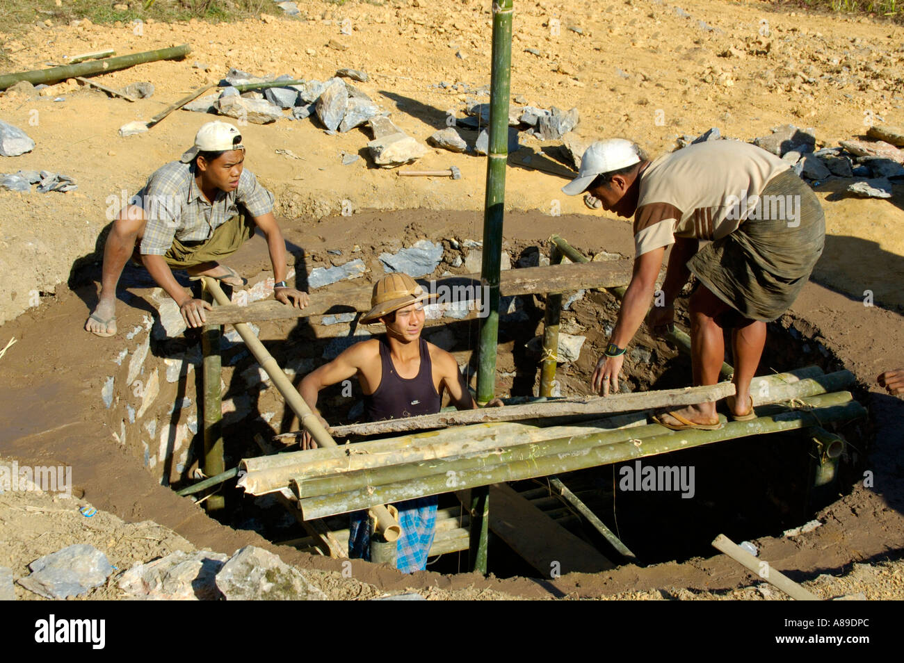 Development project men constructing a water well in Pa-laung village ...