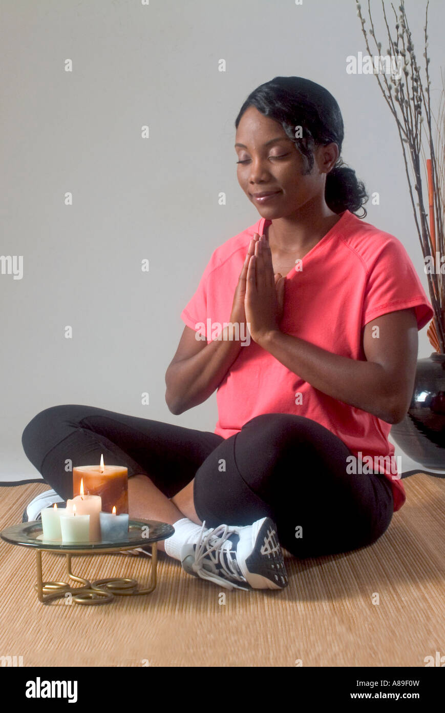 View of a young pretty ethnic black woman performing yoga Stock Photo ...