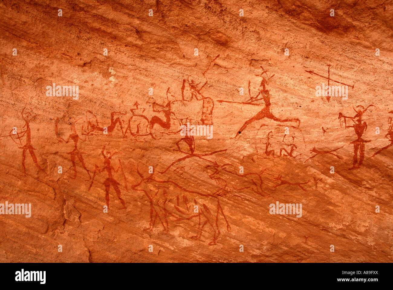 Neolithic rock drawing of humans and animals at hunt Acacus Libya Stock ...