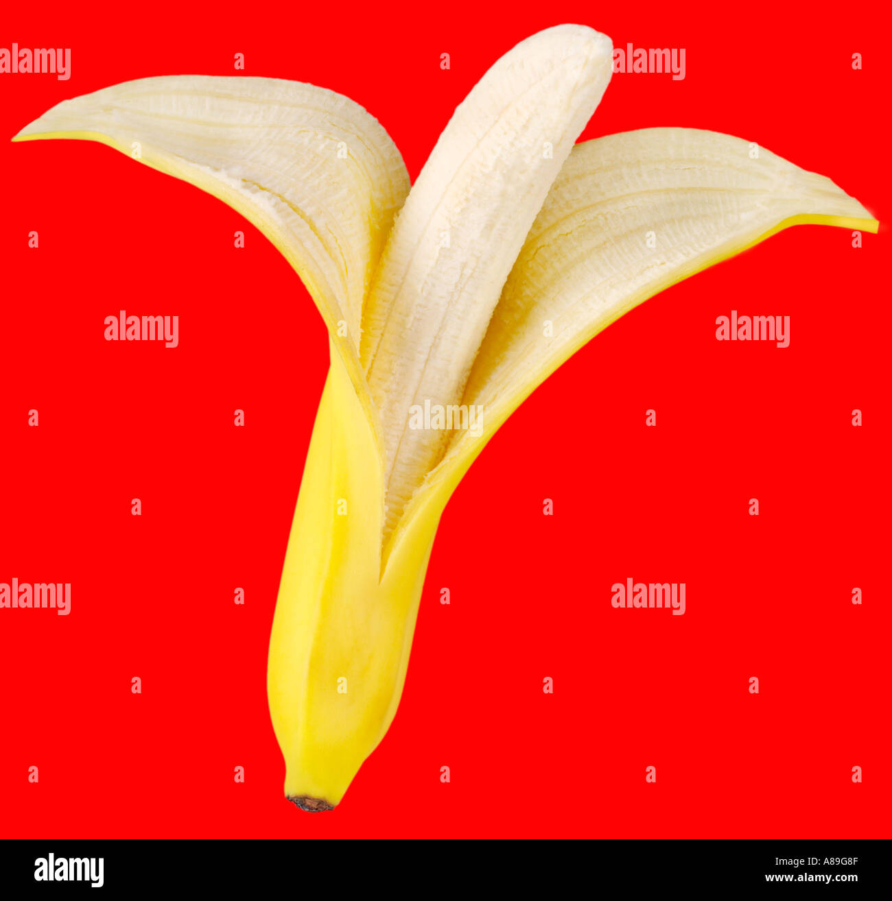 PEELED BANANA ON RED Stock Photo - Alamy