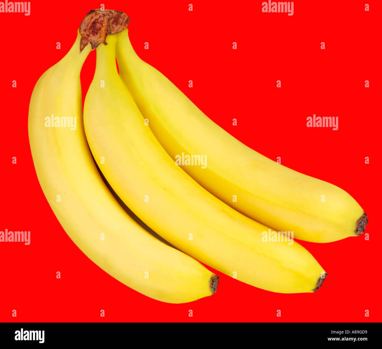 THREE BANANAS ON RED Stock Photo - Alamy