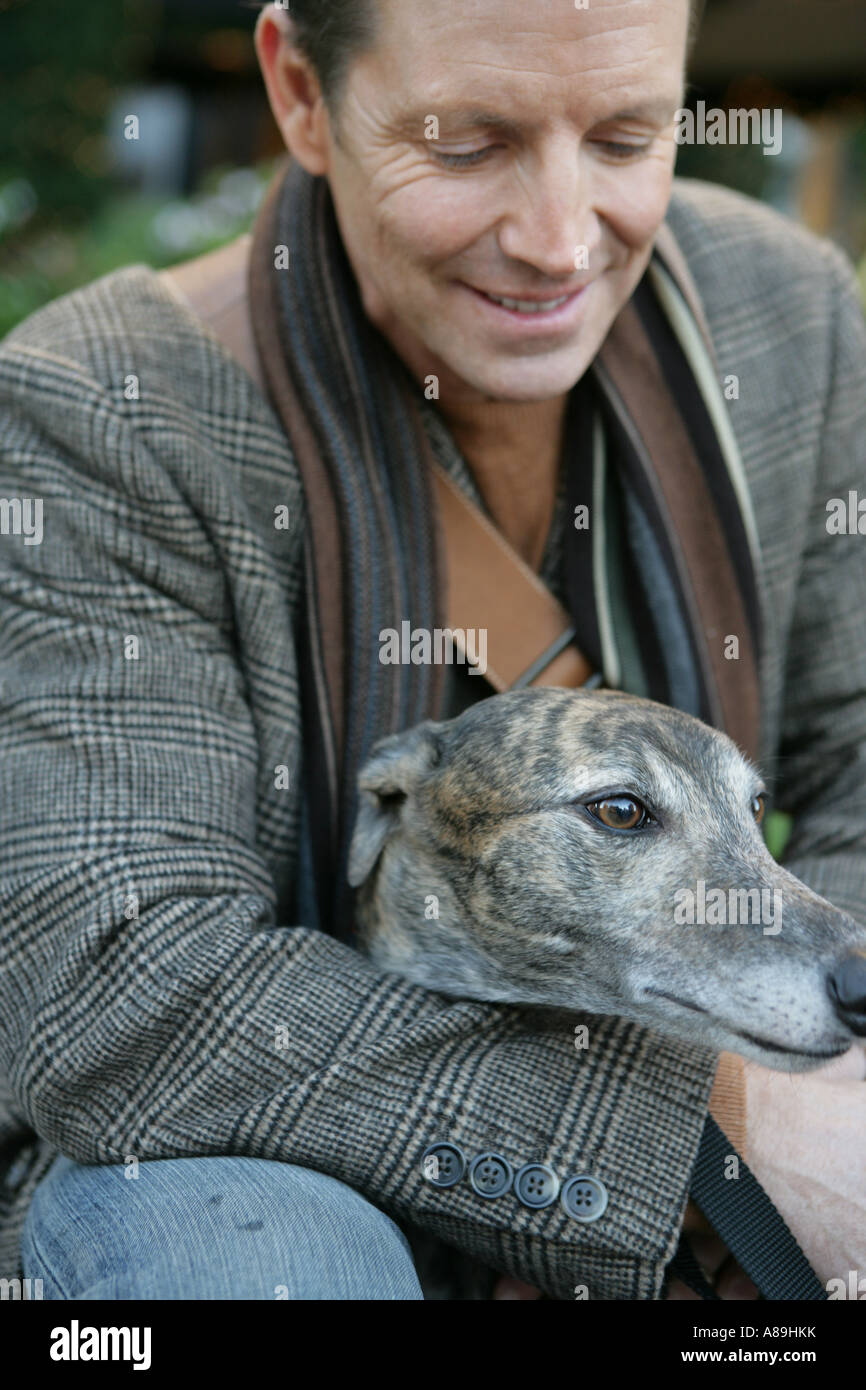 Mature man with a Whippet Stock Photo - Alamy