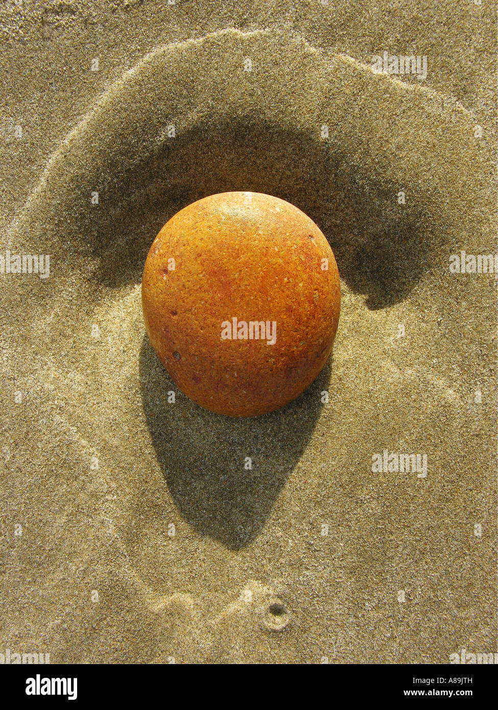 Colored pebble in the sand Stock Photo - Alamy