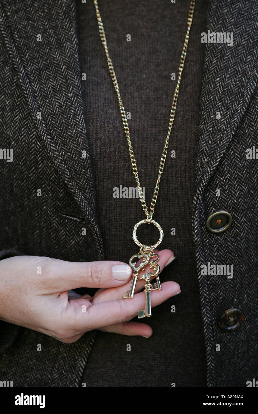 Close-up of a woman wearing a necklace with keys on it Stock Photo - Alamy