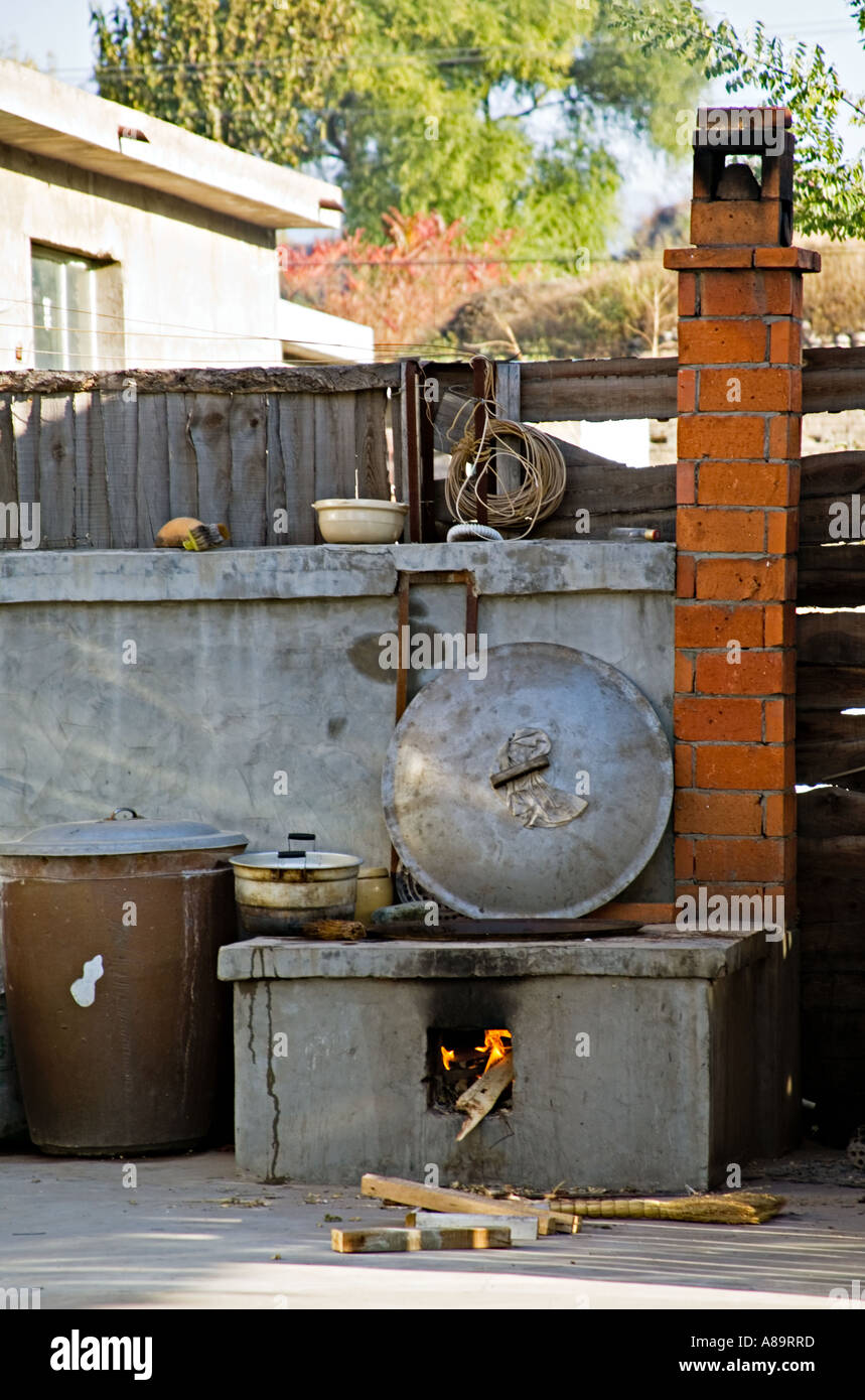 CHINA SIMATAI Wood fired stove built for a wok in the courtyard of a ...