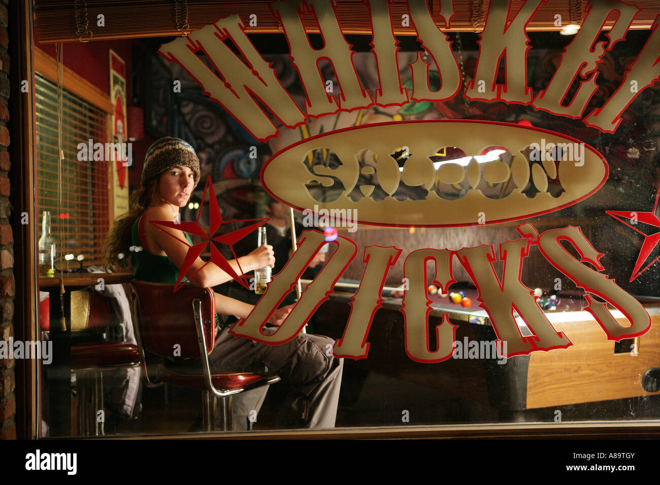 Woman sitting inside a pool hall Stock Photo - Alamy