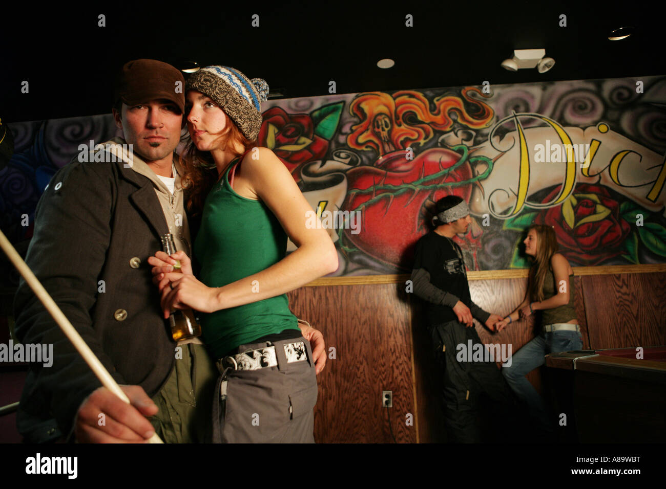 Two couples inside a pool hall Stock Photo - Alamy