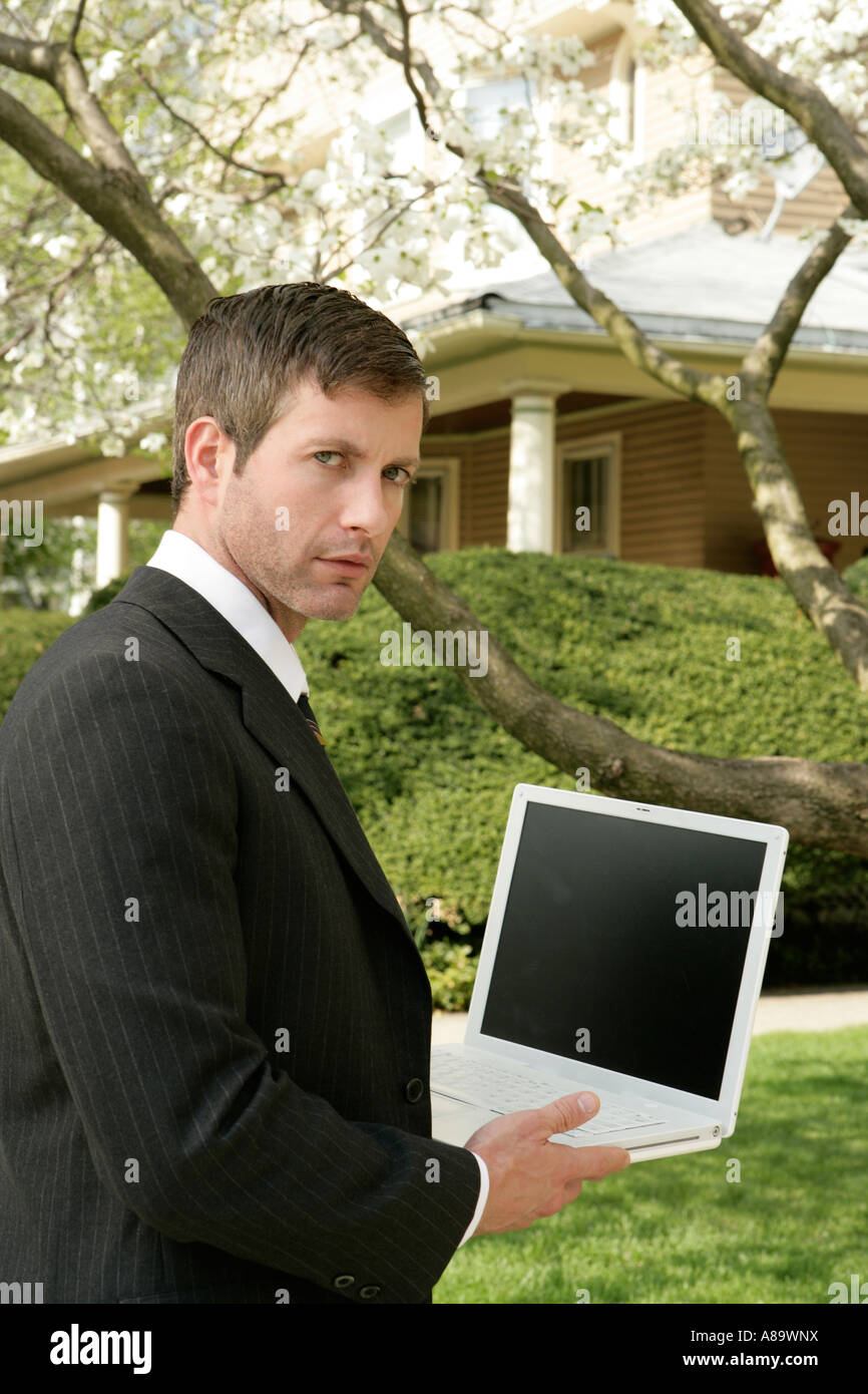 Business man with laptop outside Stock Photo - Alamy