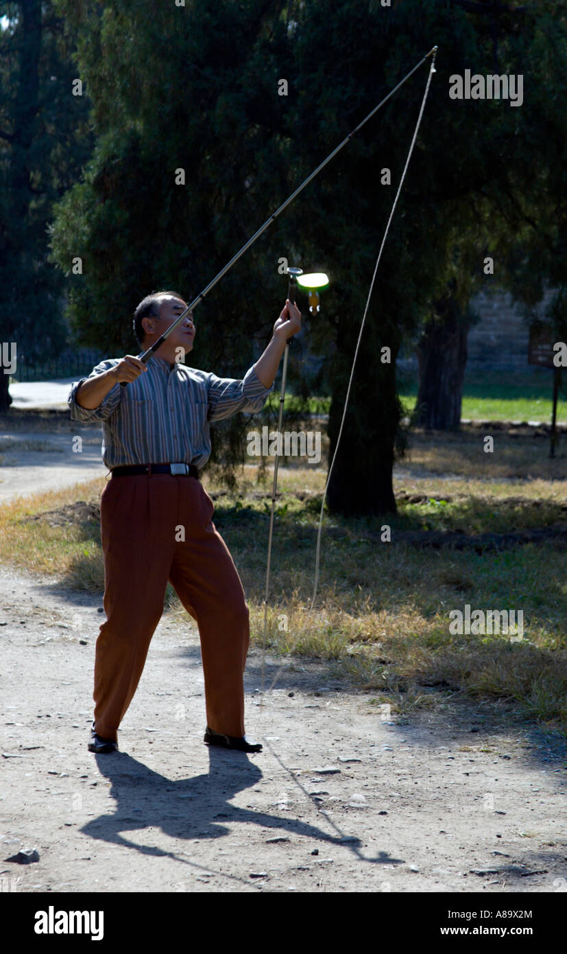 CHINA BEIJING Elderly Chinese man whirling and balancing a diabolo or ...