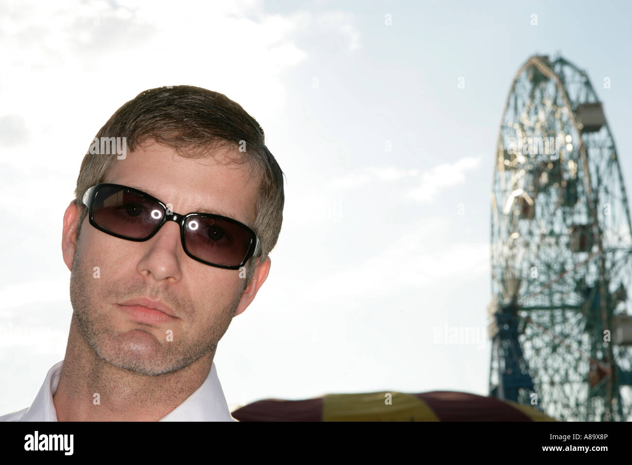 Man with shades and ferris wheel in the background Stock Photo - Alamy