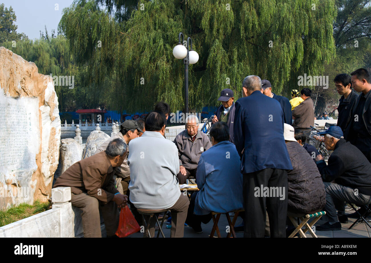 CHINA BEIJING A crowd of Chinese men gathers to watch a card game being ...