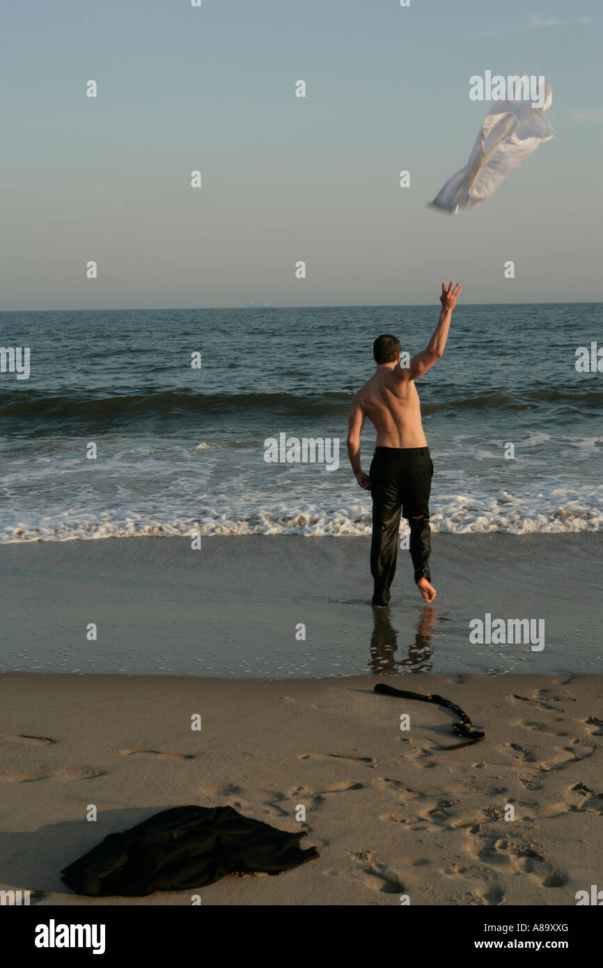 Man tossing off his clothes Stock Photo - Alamy