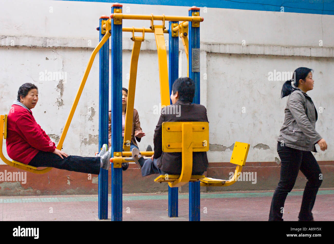 CHINA BEIJING Chinese men and women exercising on playground equipment ...