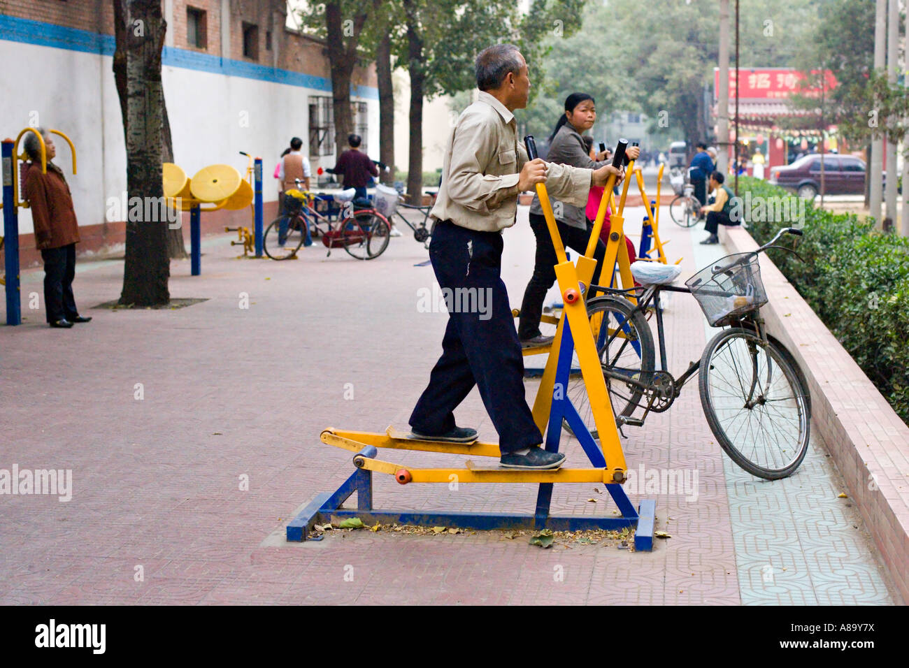 CHINA BEIJING Chinese men and women exercising on playground equipment ...