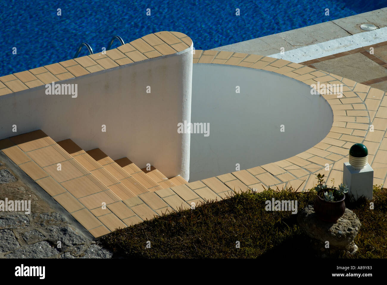 Architectural image of steps and curved wall leading down to a swimming ...