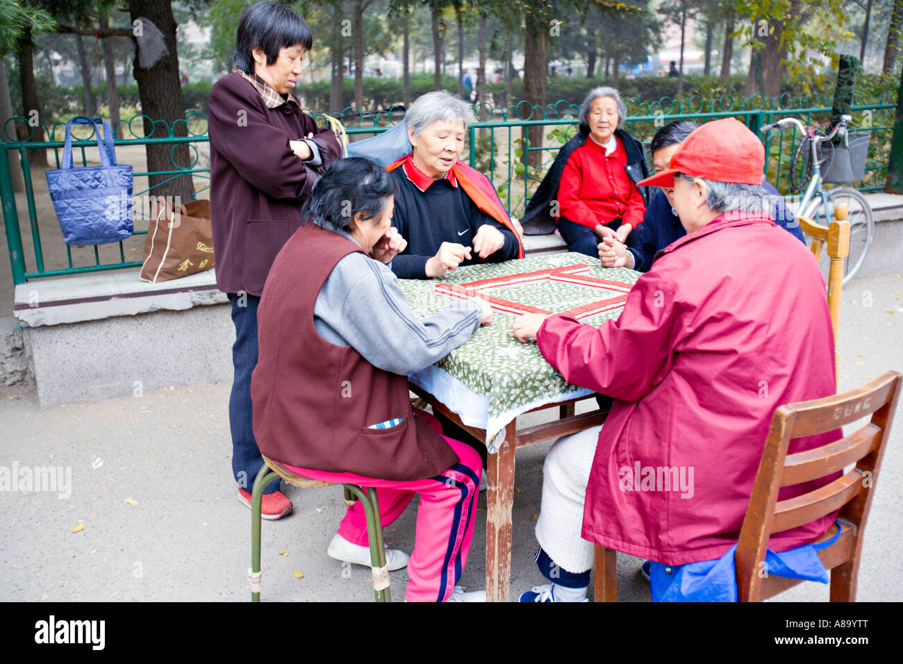 CHINA BEIJING Elderly Chinese women and one man playing mahjong a ...