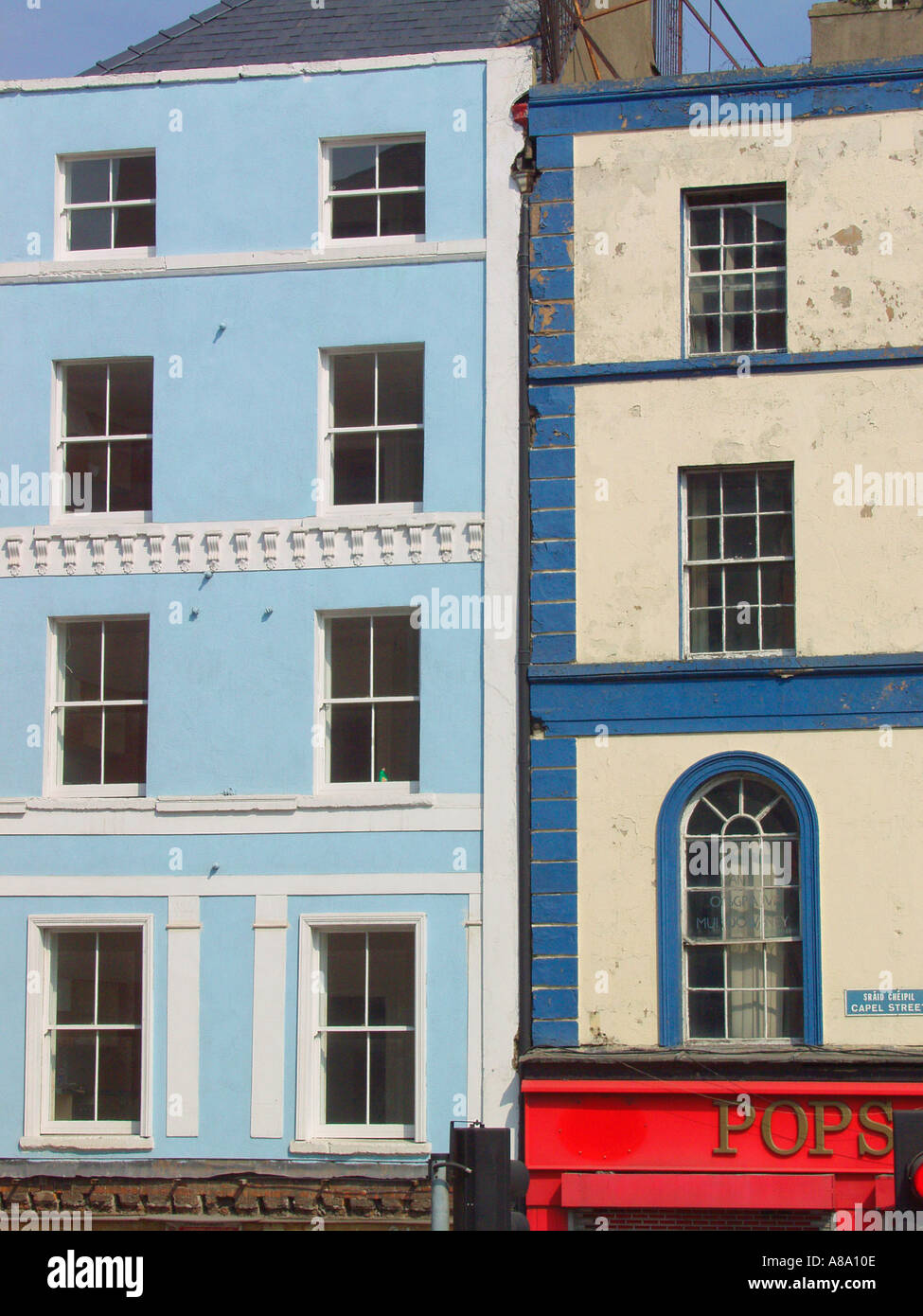 Georgian facades, showing signs of decay, shop fascias visible below ...