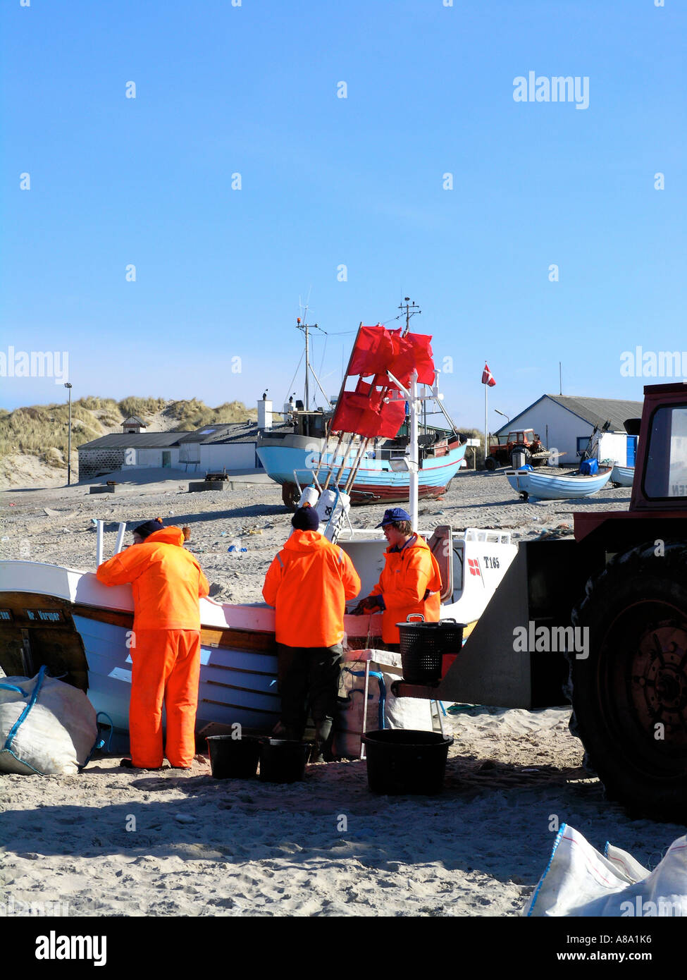 Fishermen cleaning and sorting the catch Stock Photo - Alamy