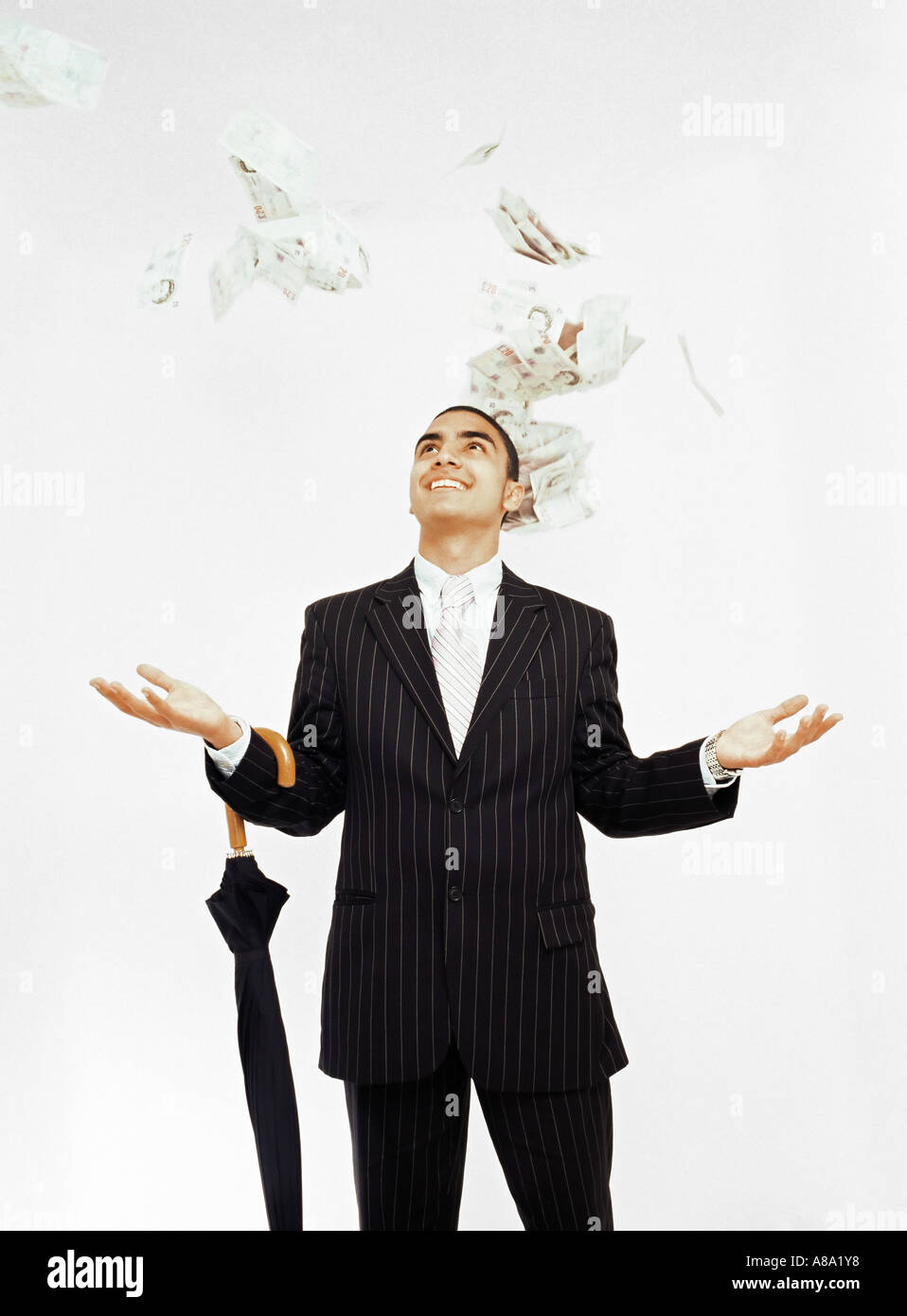 Money falling on businessman Stock Photo - Alamy