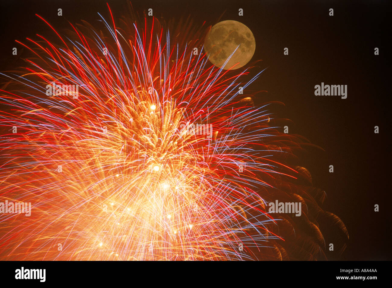 Fireworks exploding on full moon night Stock Photo - Alamy
