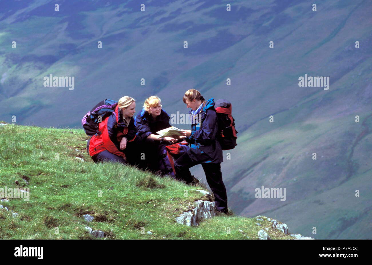 Group of female hill walkers navigating their way through the hills ...
