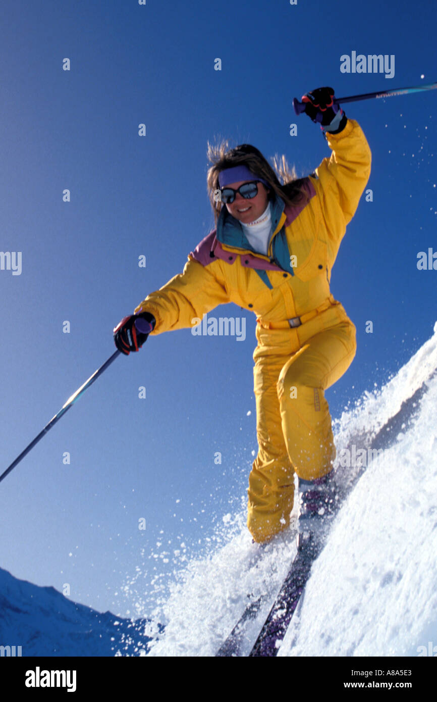 Female extreme skier skiing down sheer drop Stock Photo - Alamy