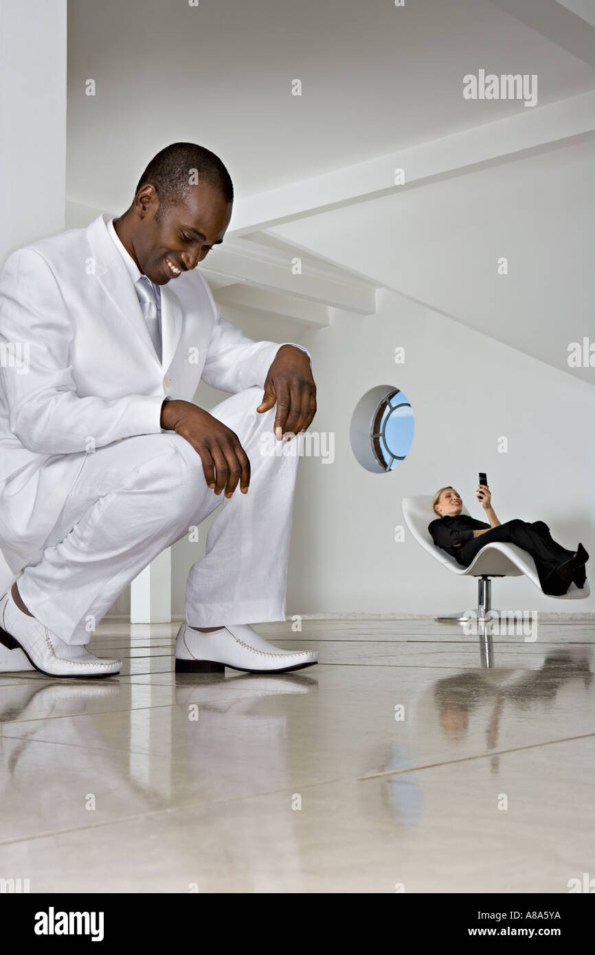 Modern woman crouching chair hi-res stock photography and images - Alamy