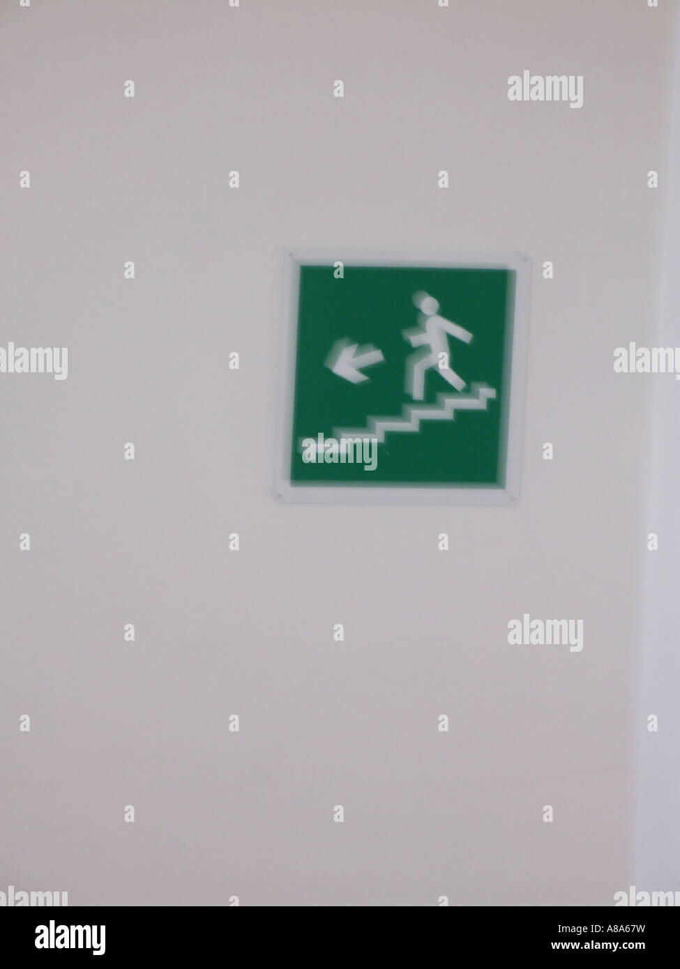 emergency exit sign notice on wall Stock Photo - Alamy