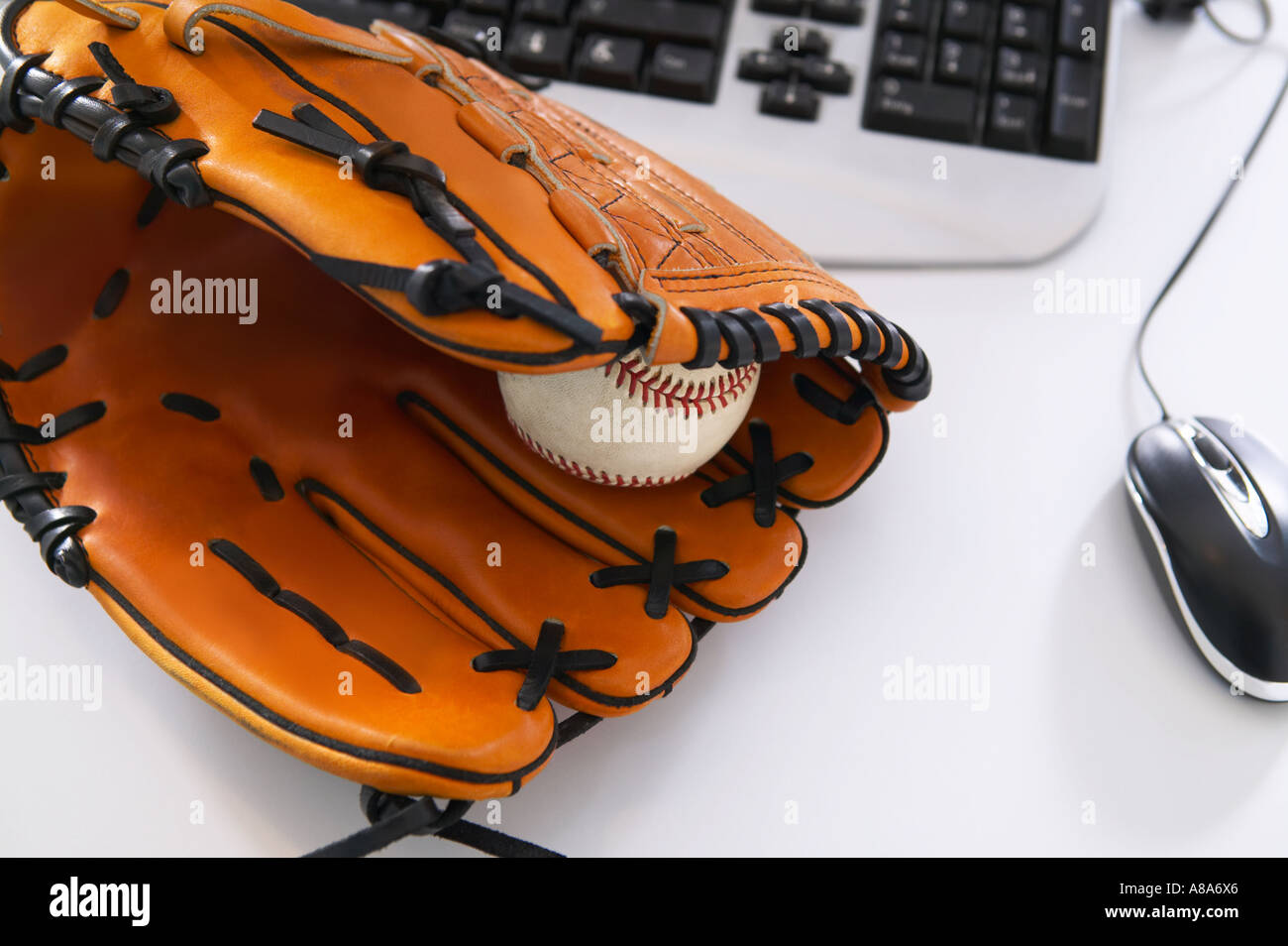 Baseball bat and glove on desk Stock Photo - Alamy