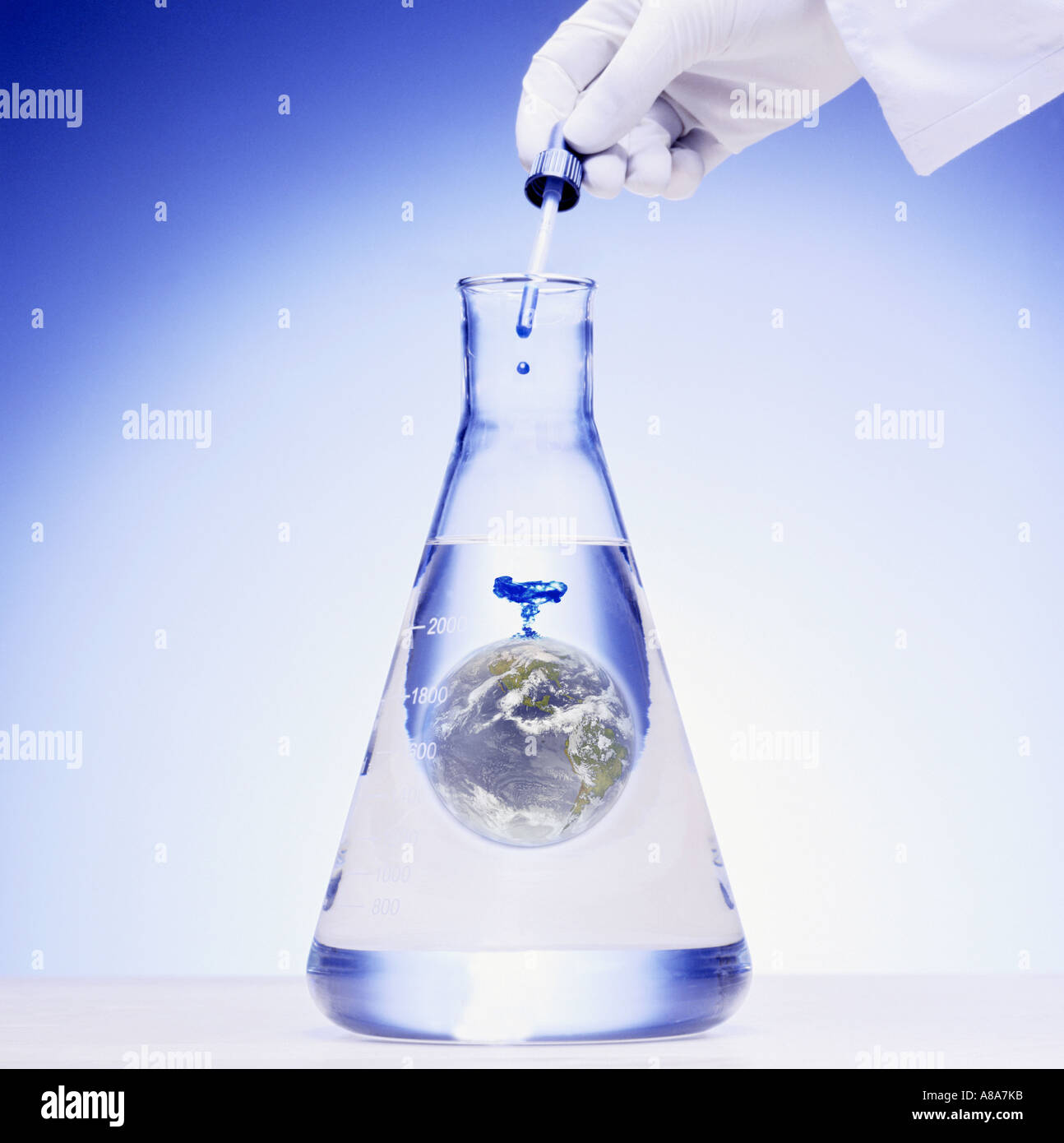 Scientist adding chemical to the world Stock Photo - Alamy