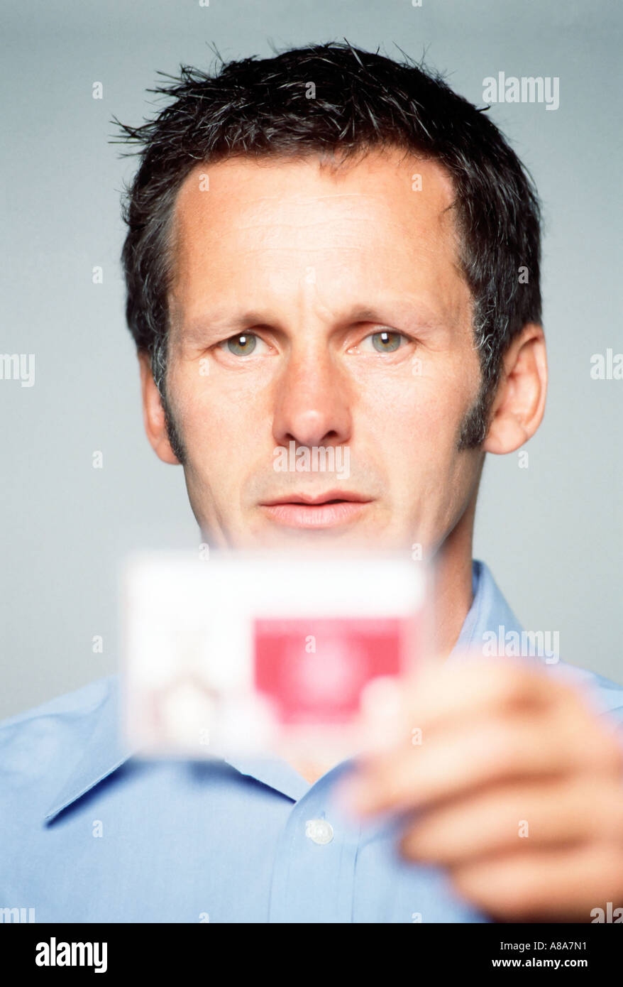 Man holding an identity card Stock Photo - Alamy