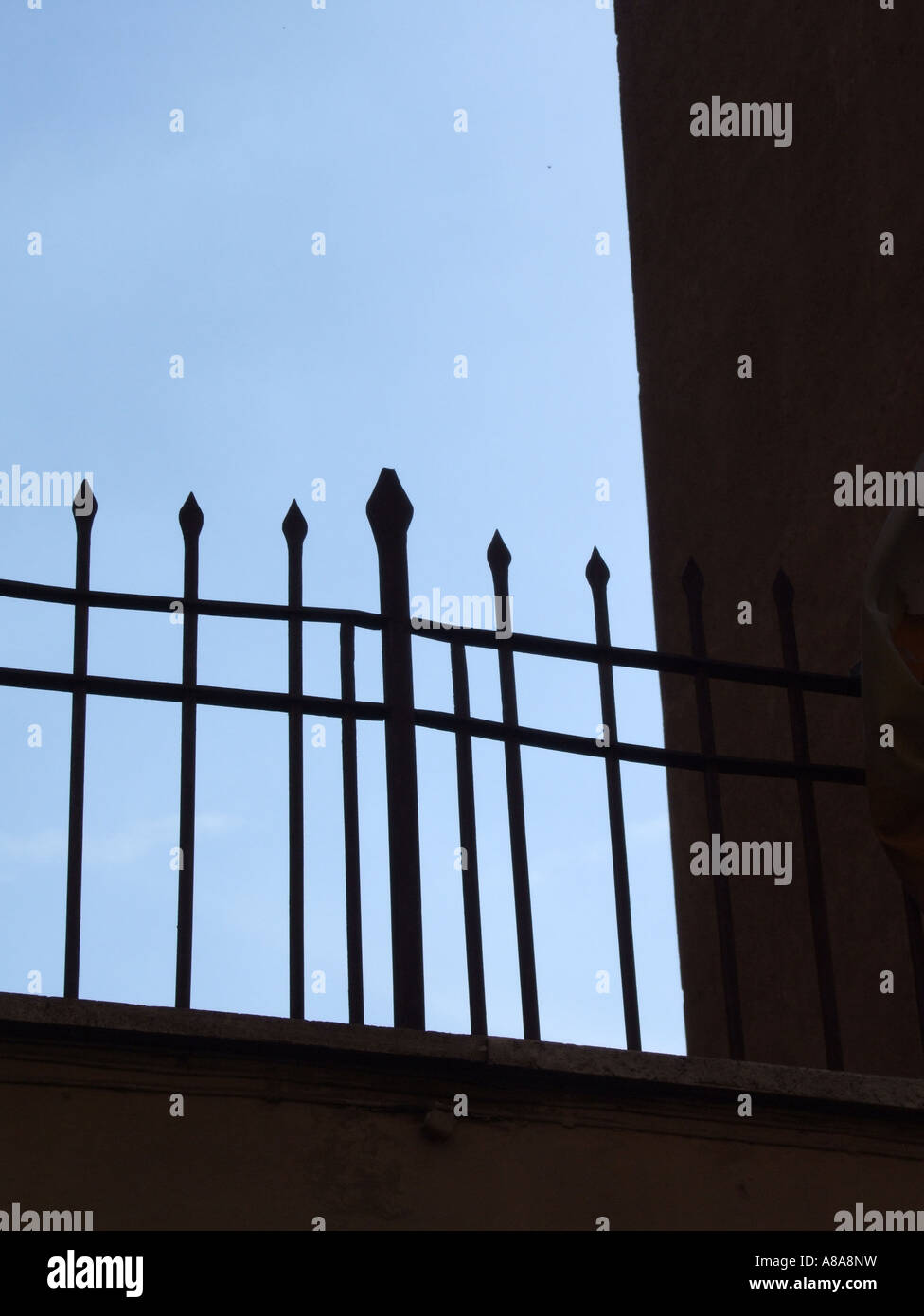 high fence and building Stock Photo - Alamy