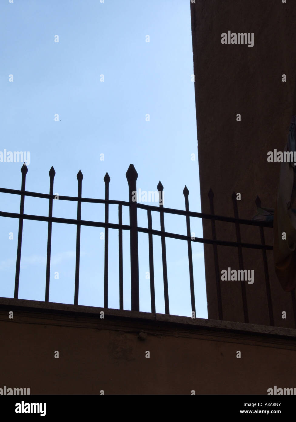 high fence and building Stock Photo - Alamy