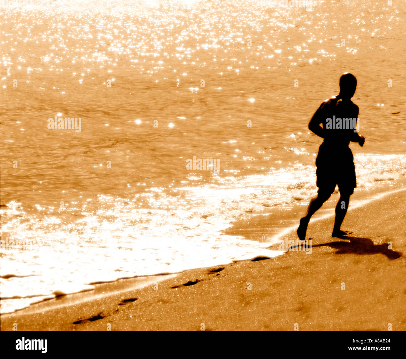 Man Jogging on the Beach Stock Photo - Alamy