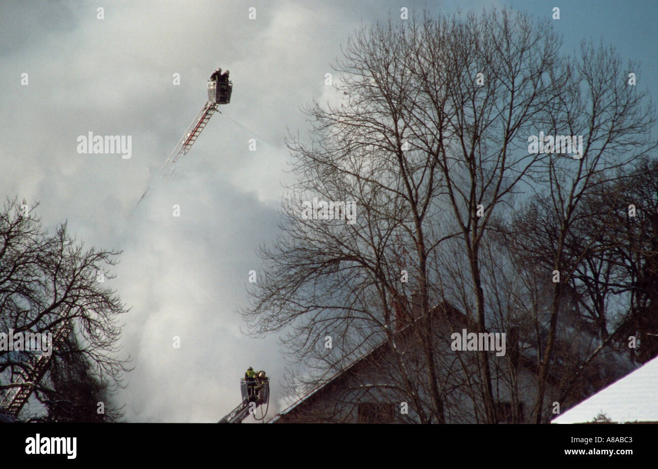 Fire fighters dousing the flames and smoke coming from burning horse ...