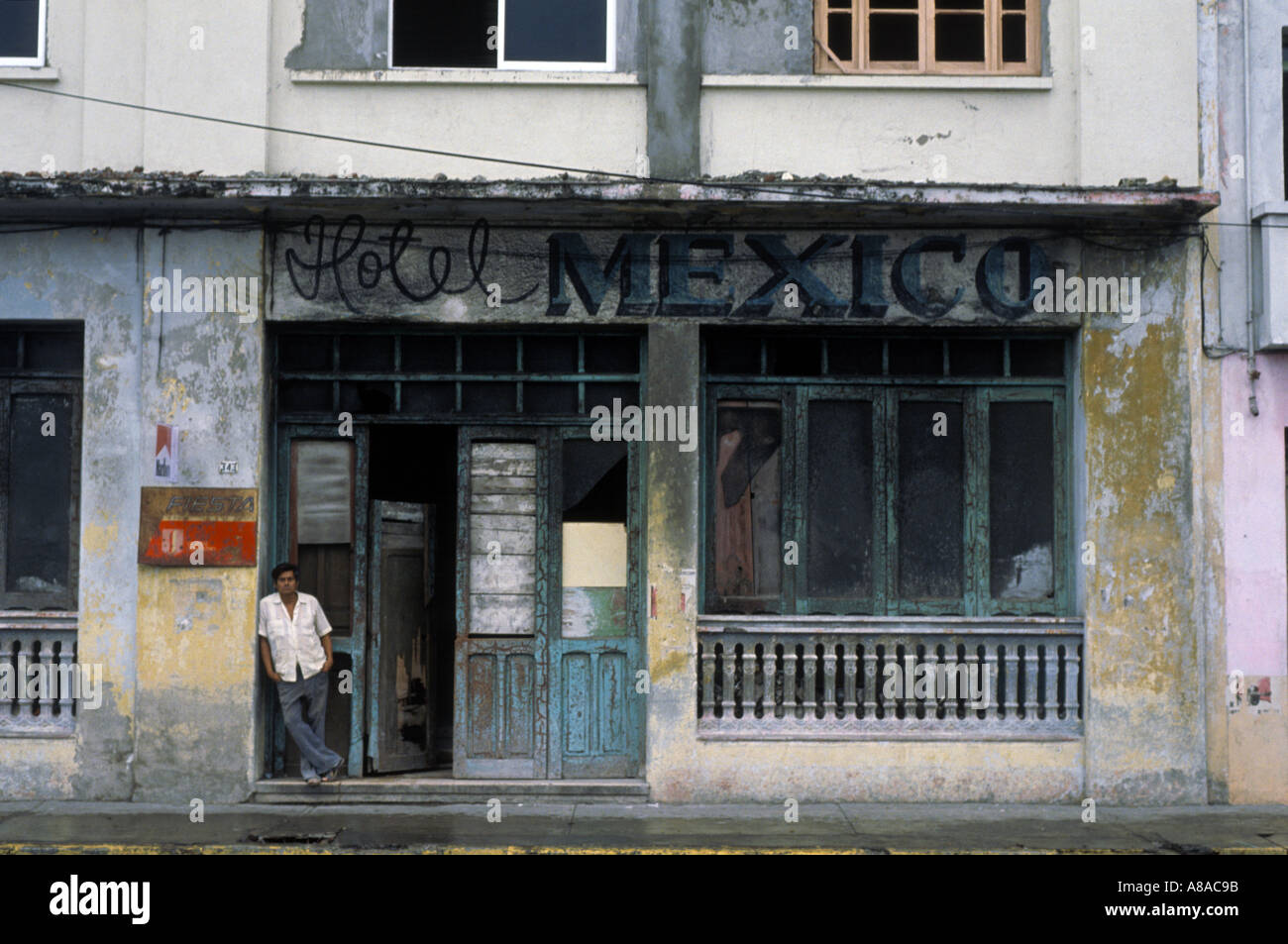 Man standing in the doorway of a run down hotel in the port of Veracruz ...